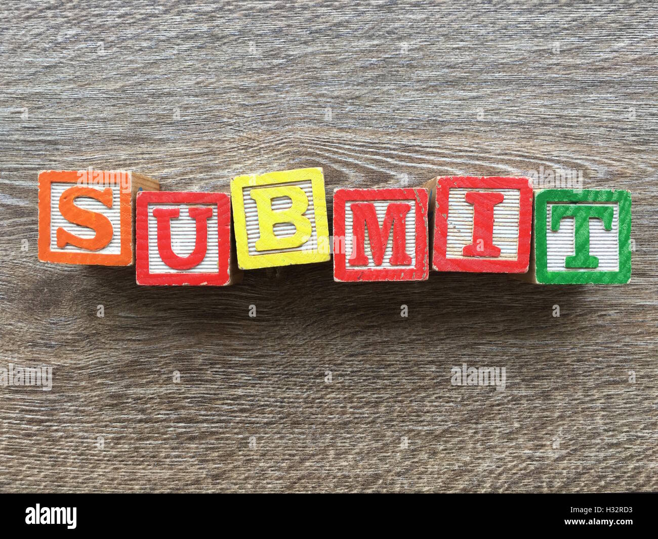 Alphabet wood block letters forming the word SUBMIT, it is a way for ...