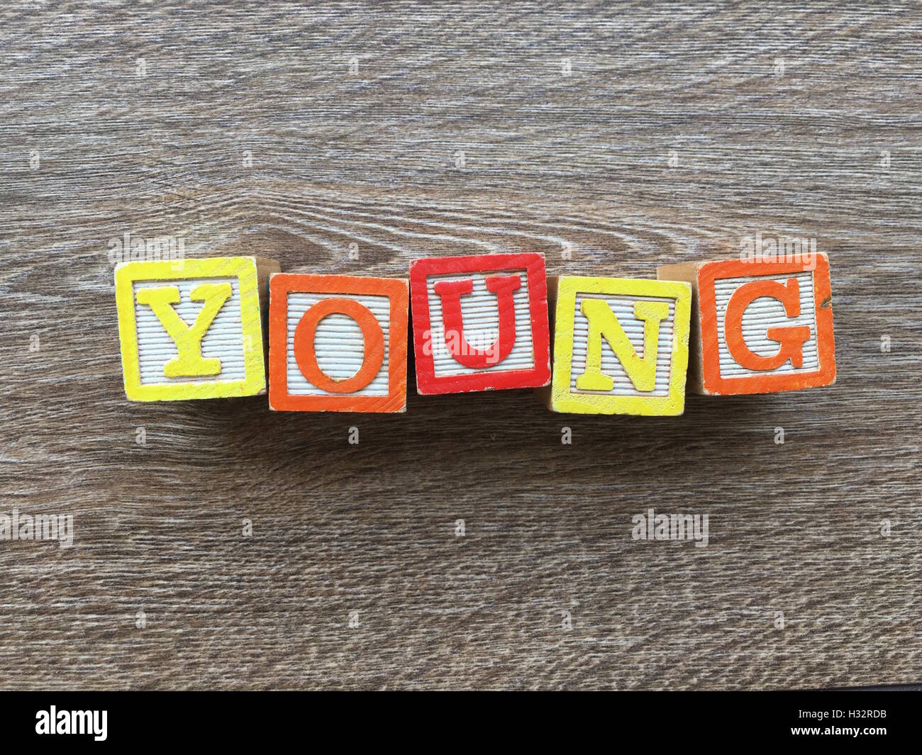 Alphabet wood blocks making the word YOUNG Stock Photo - Alamy