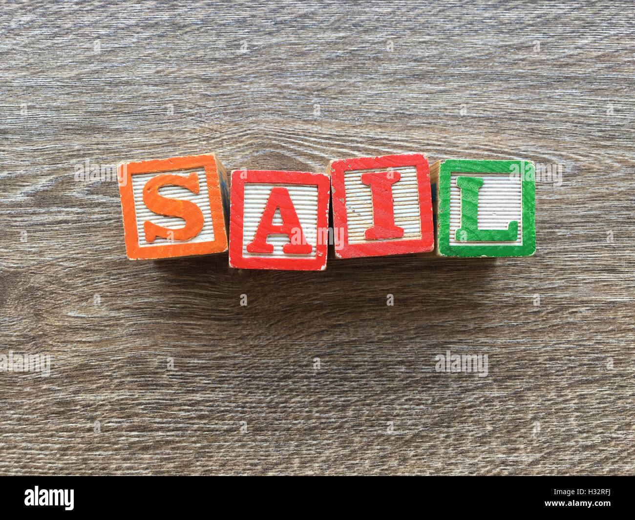 Alphabet wood blocks making the word SAIL Stock Photo - Alamy