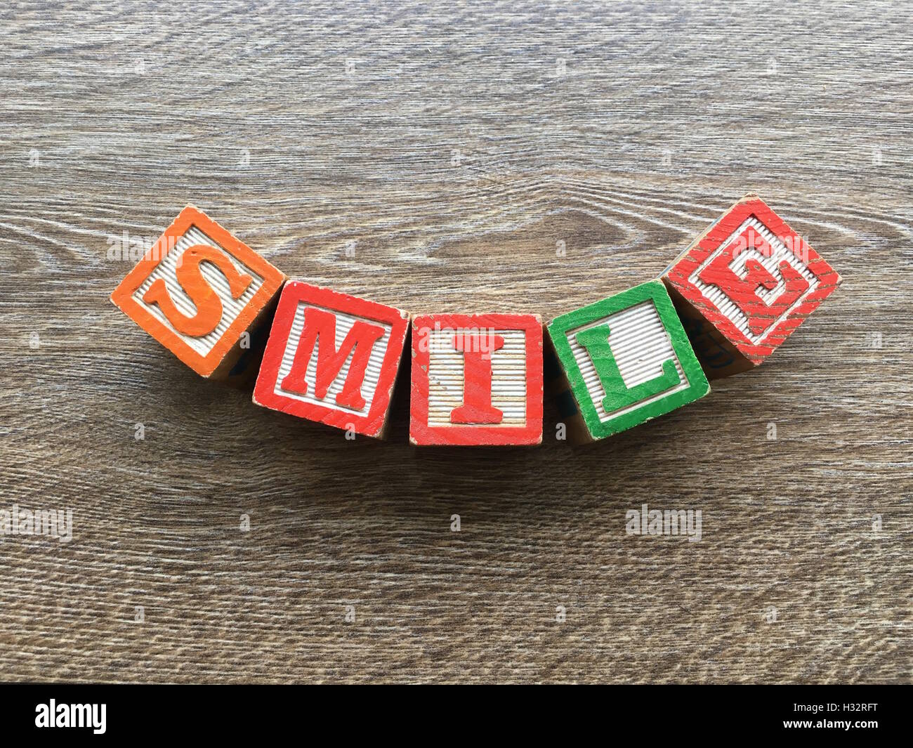 Alphabet wood blocks making the word SMILE Stock Photo - Alamy