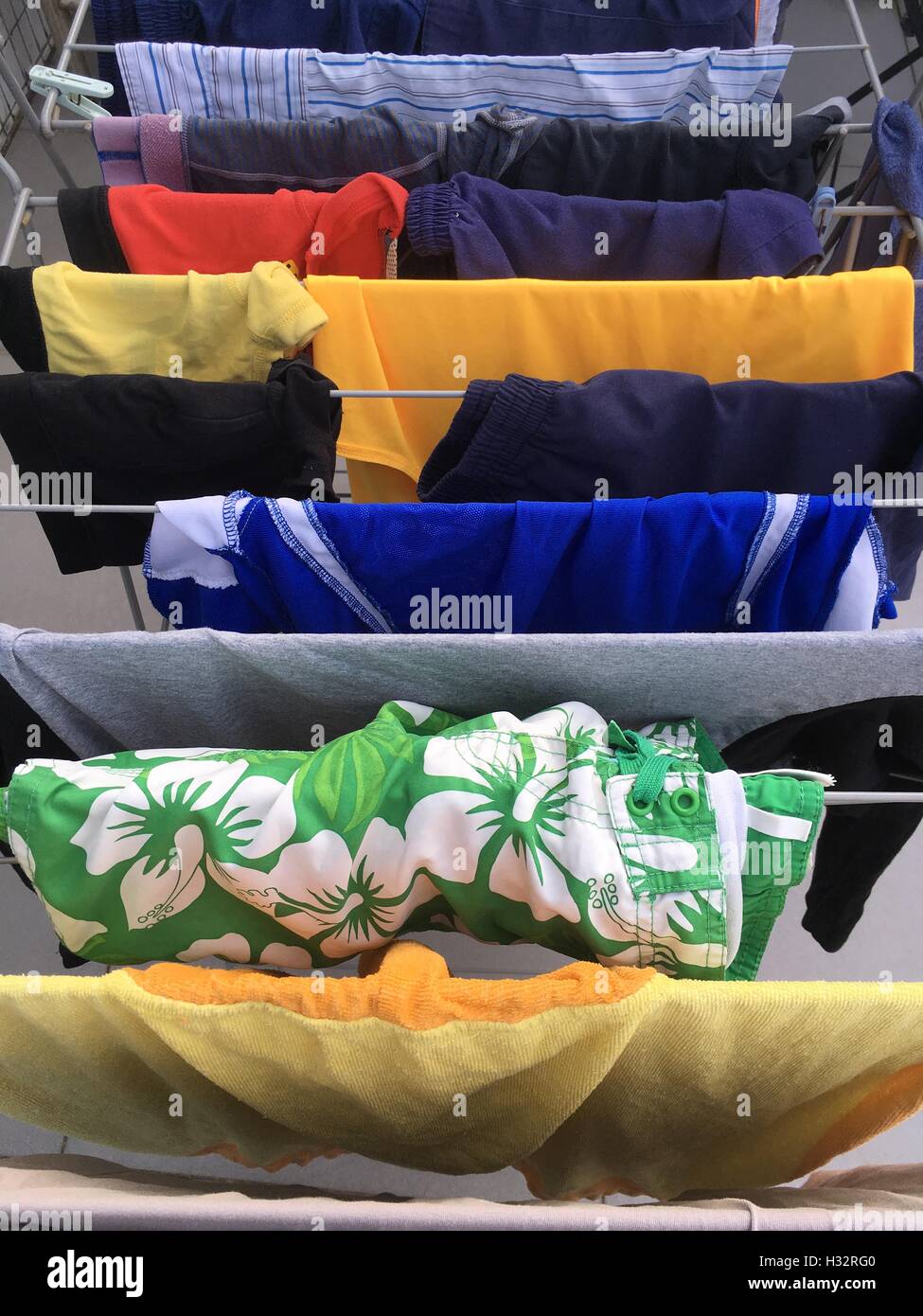 Clothes dryer full of colorful clothes ready to get dry after being ...