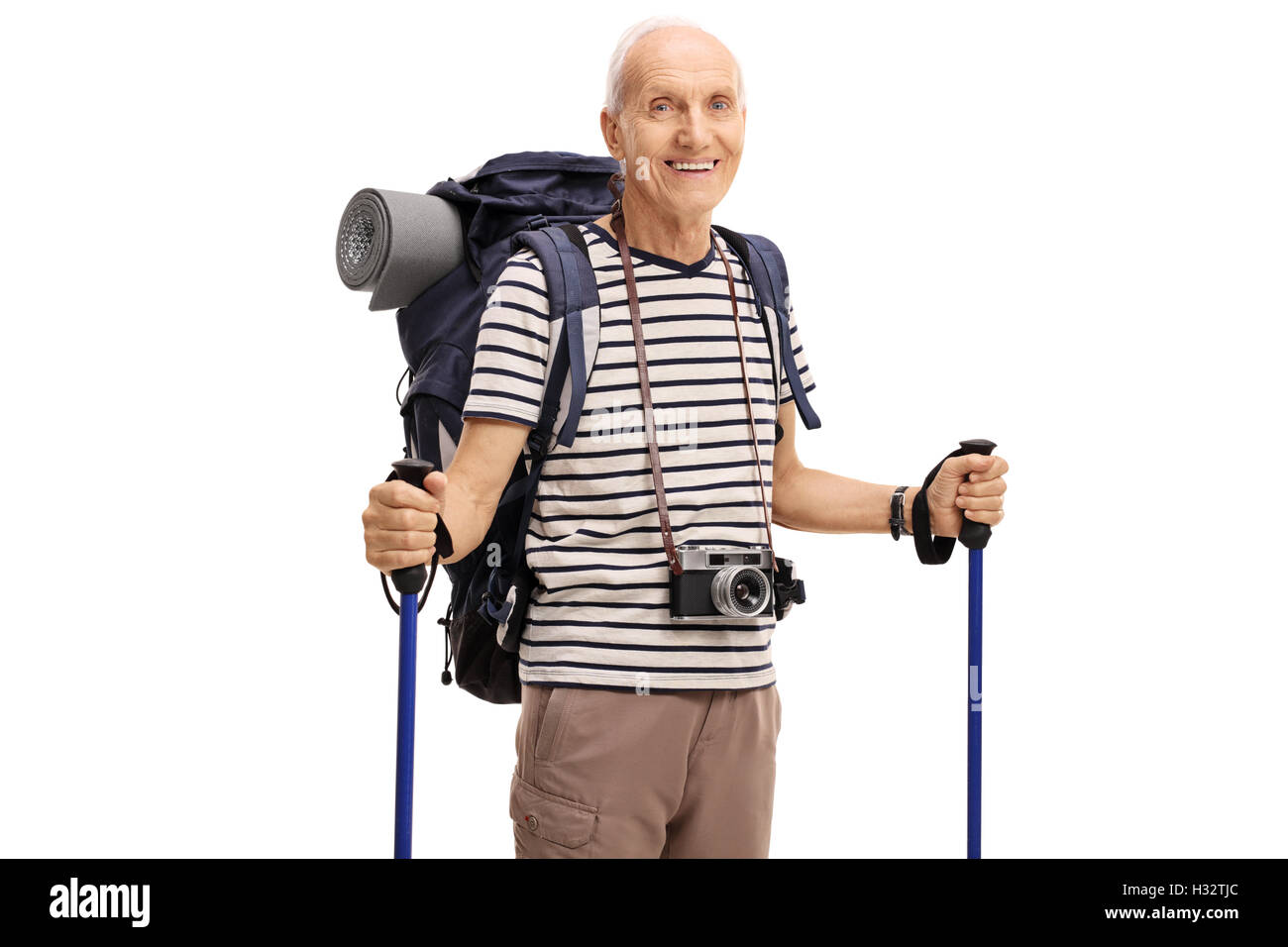 Happy senior hiker posing and looking at the camera isolated on white ...