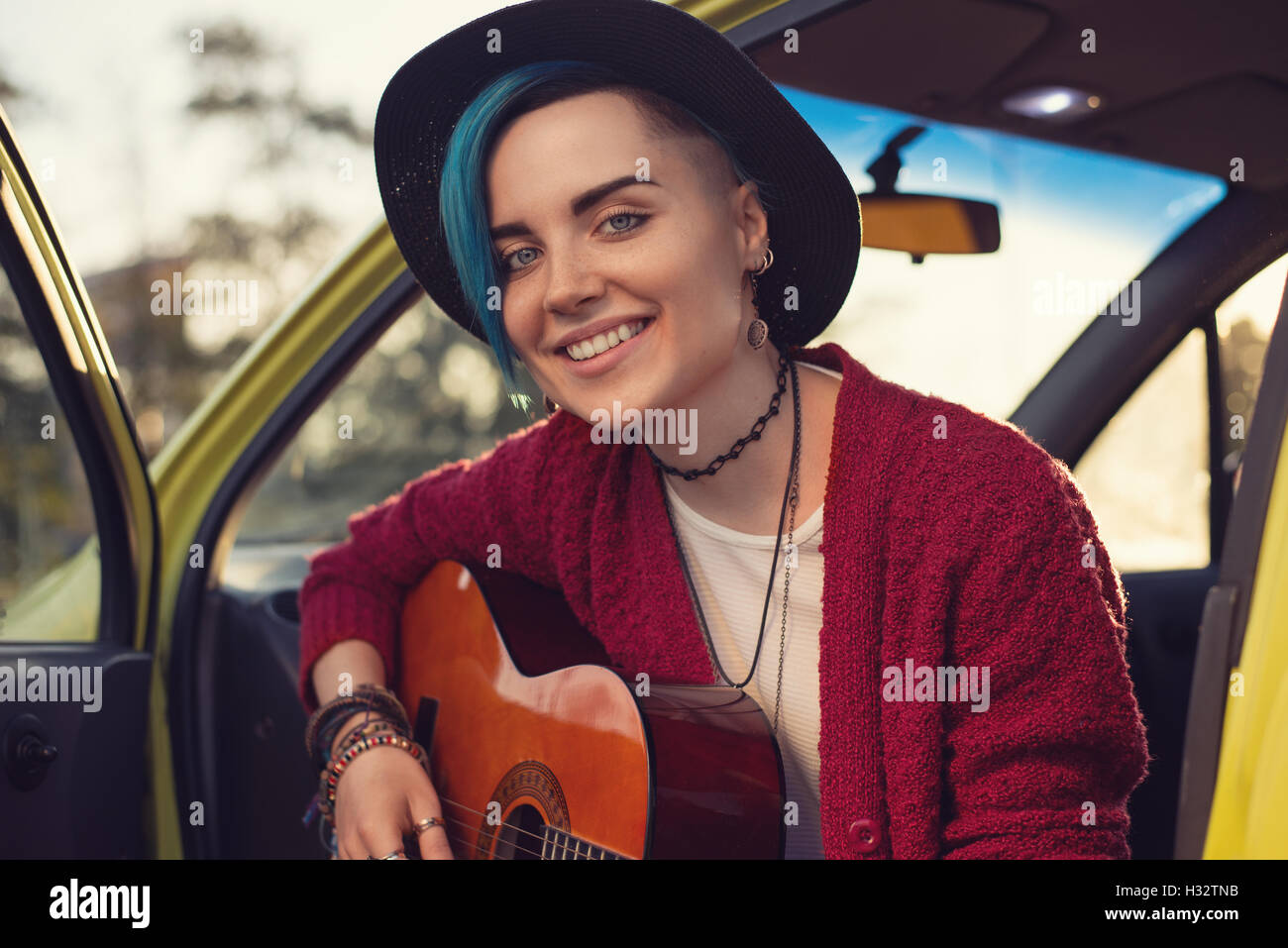 Closeup face portrait of folk singer with guitar in car outdoors Stock ...