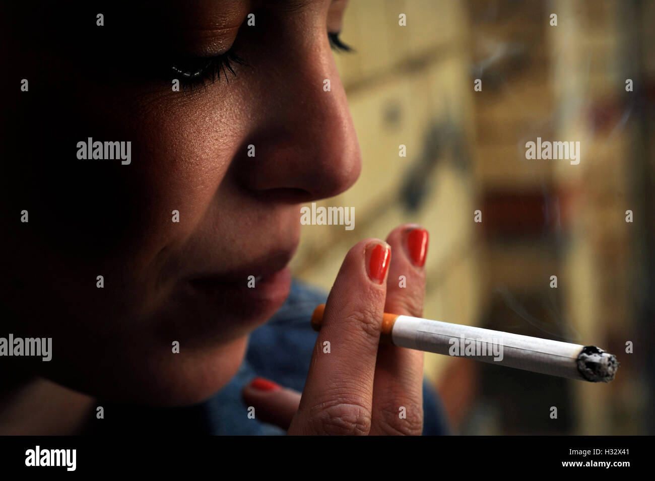 A young female smoking a cigarette UK Stock Photo - Alamy