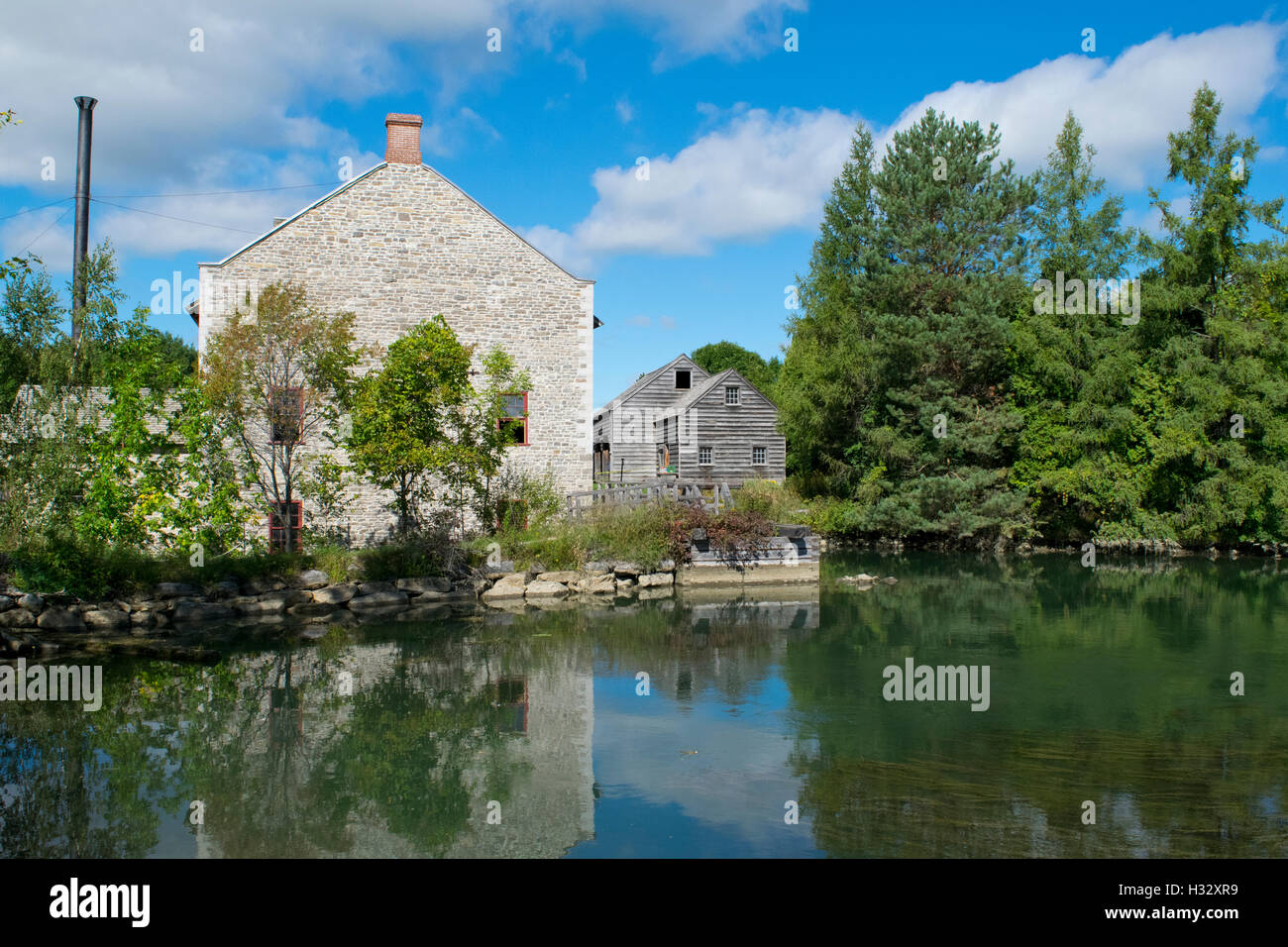 The Flour Mill at Upper Canada Village, reflected in the pond Stock ...