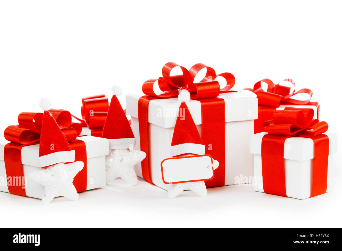 White gift boxes with red ribbons, stars with santa claus hats isolated ...
