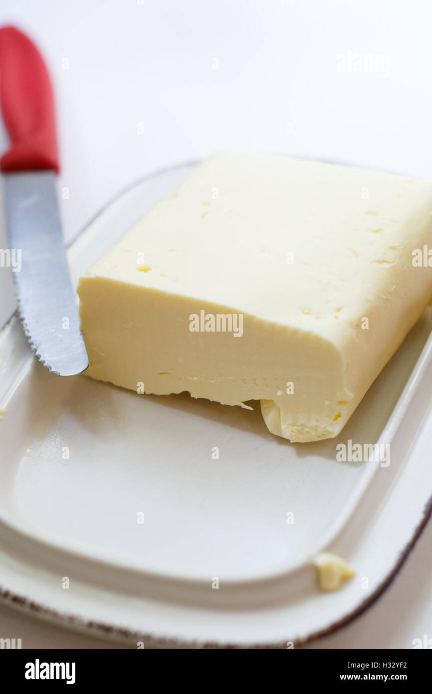 Pat of fresh farm butter on a butter dish with a knife Stock Photo - Alamy