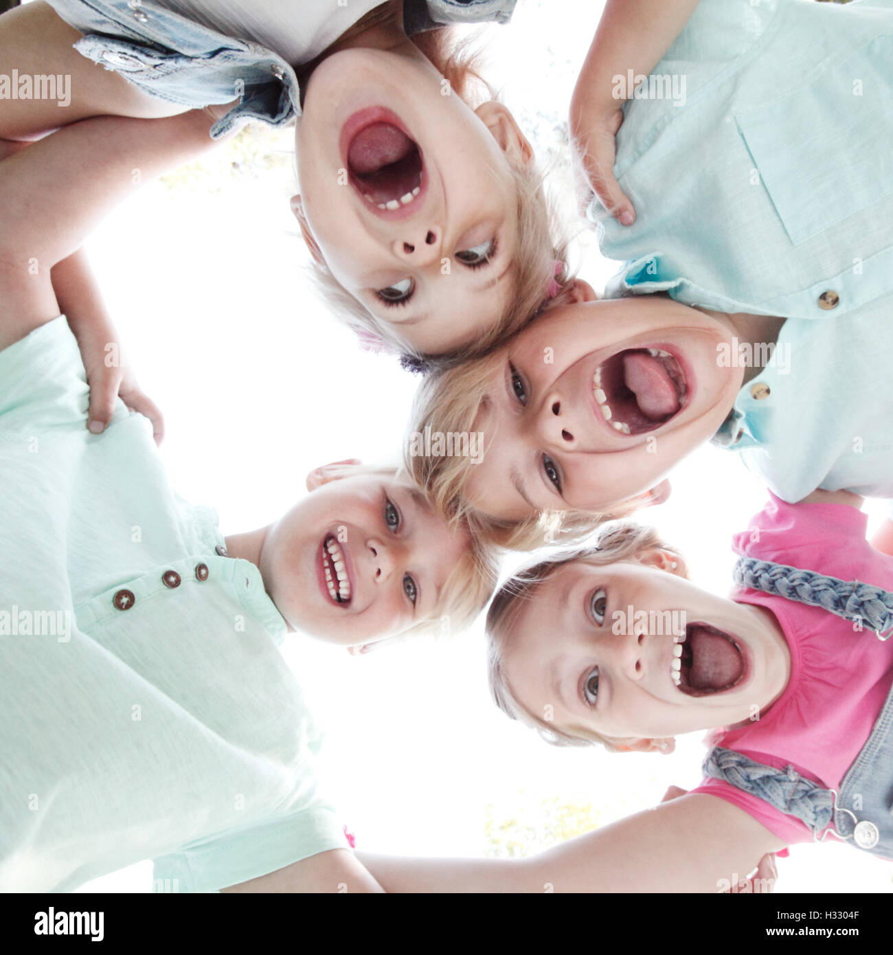 Group of smiling children looking down into camera Stock Photo - Alamy
