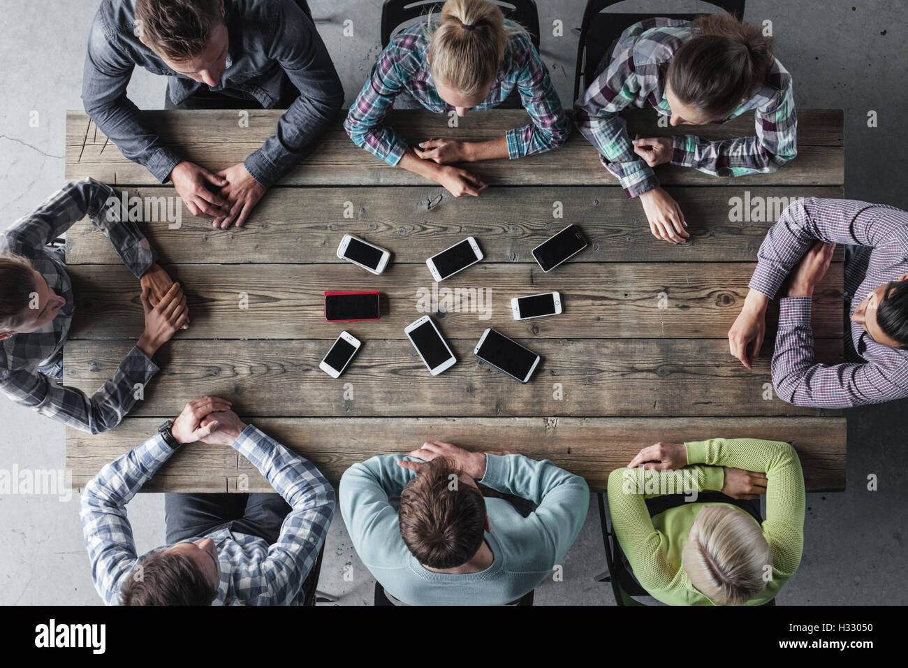 Hipster people sitting around the table without smartphones Stock Photo ...