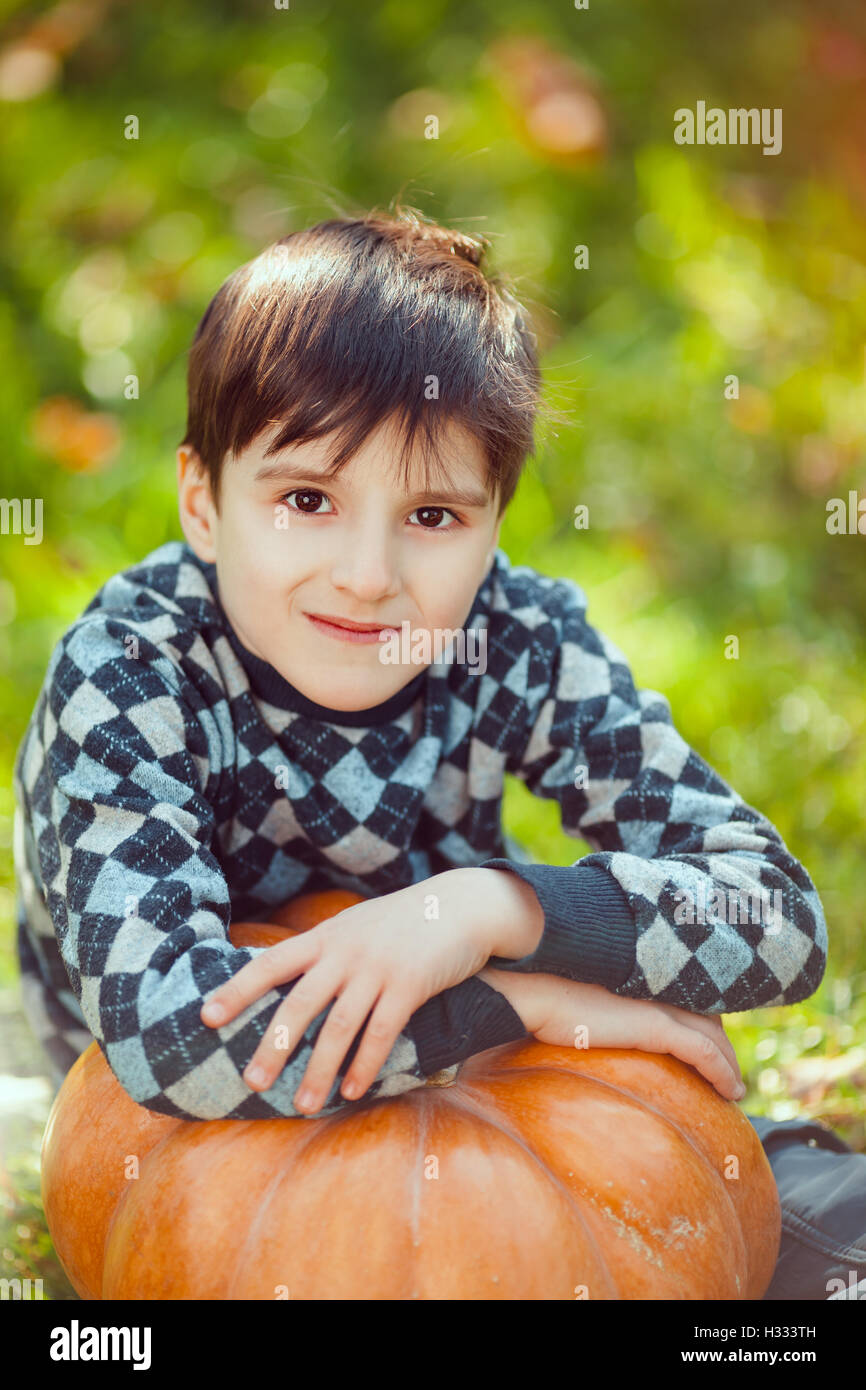 Boy Playing With Pumpkin Stock Photo - Alamy