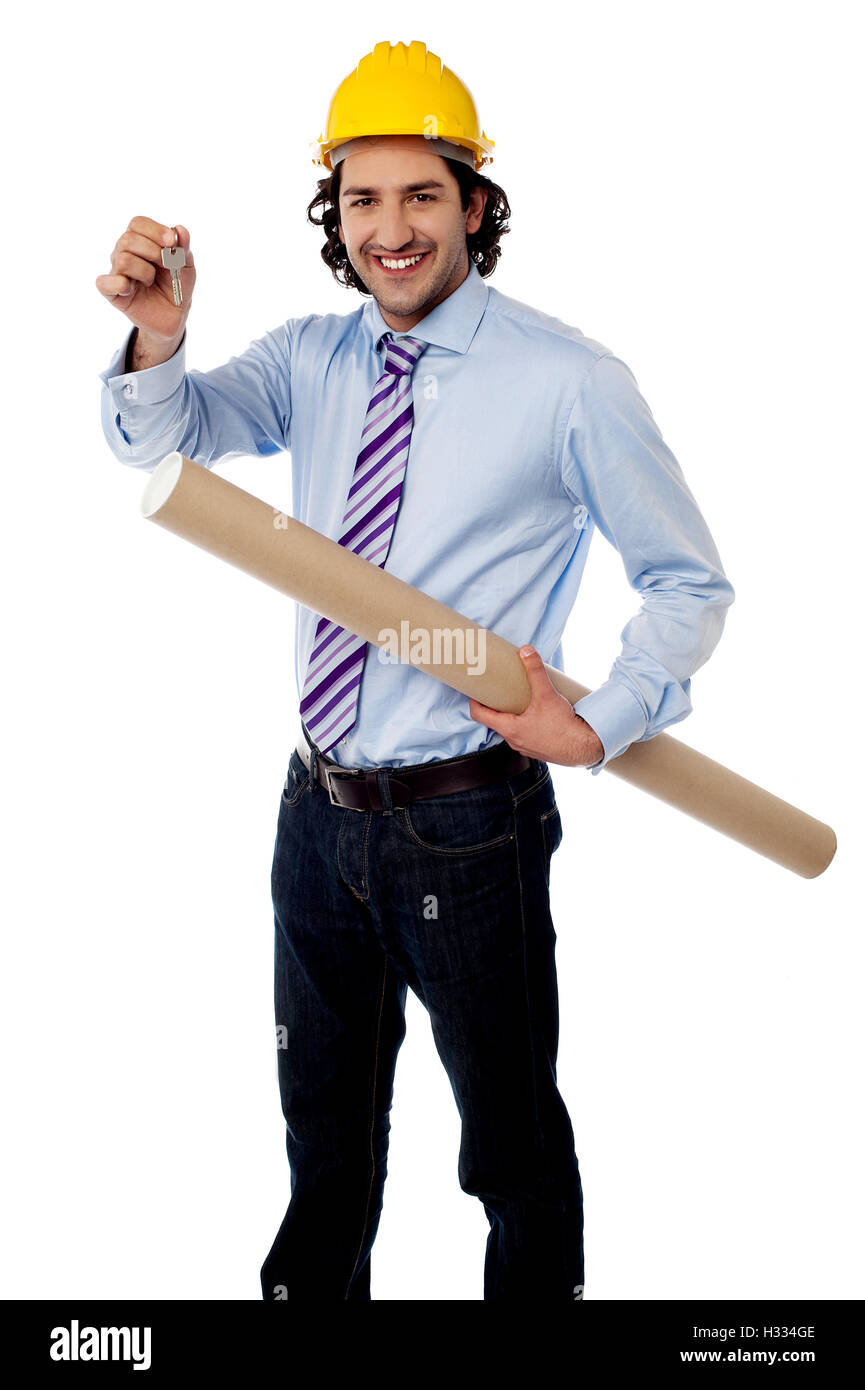 Young engineer with key and blueprint Stock Photo - Alamy