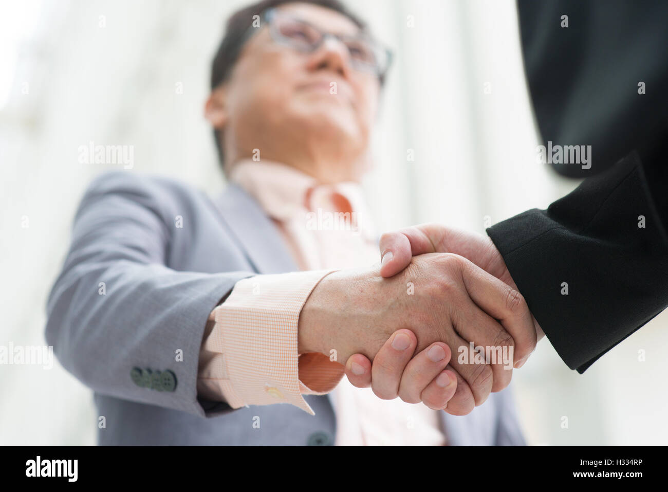Asian business men handshaking Stock Photo - Alamy