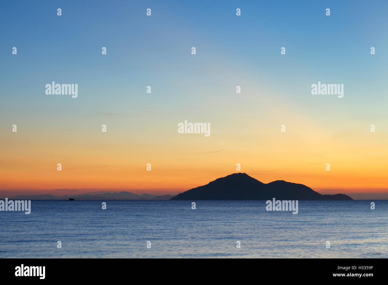 Sunset seascape with small island Stock Photo - Alamy