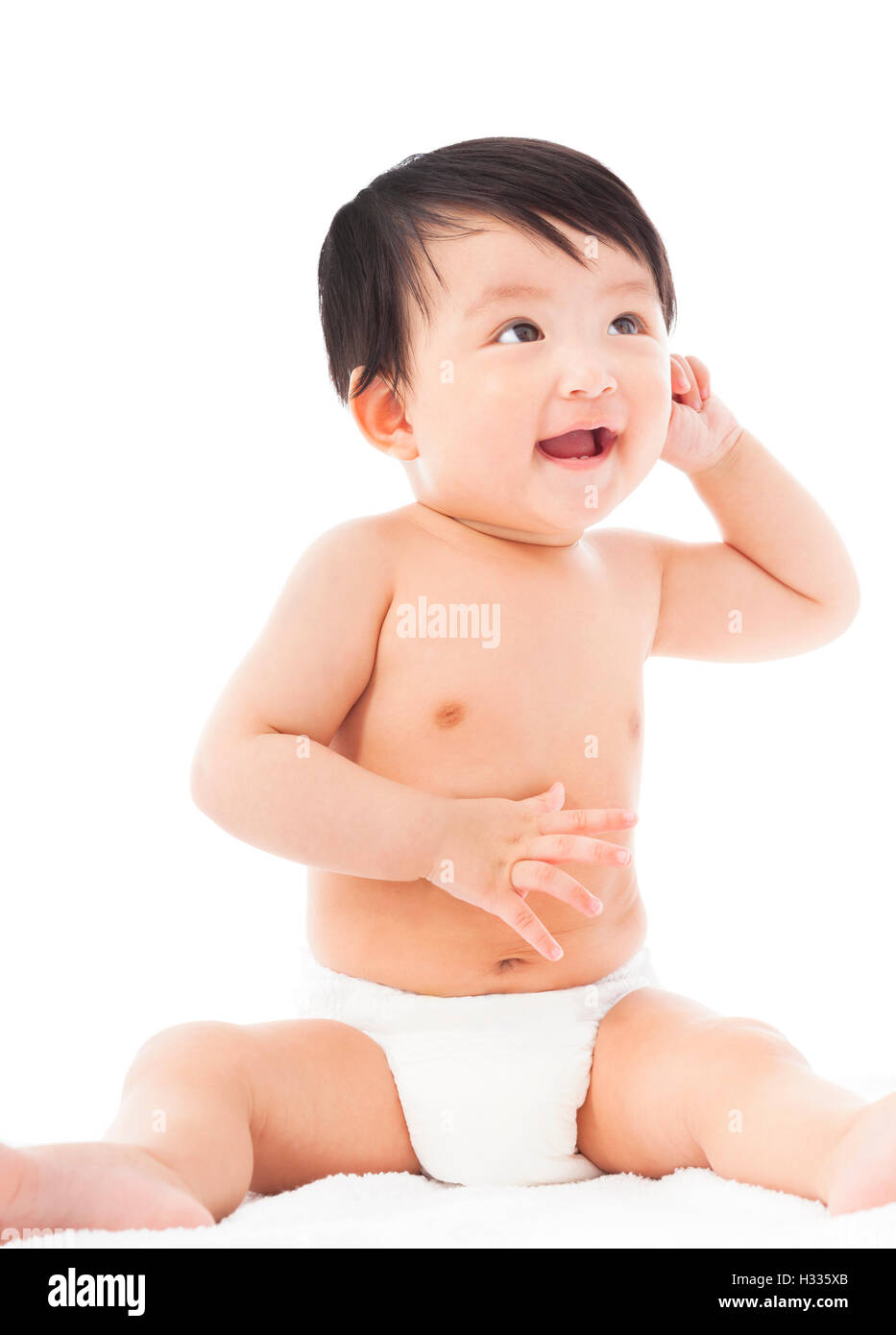 smiling Infant child baby sitting and look up Stock Photo - Alamy