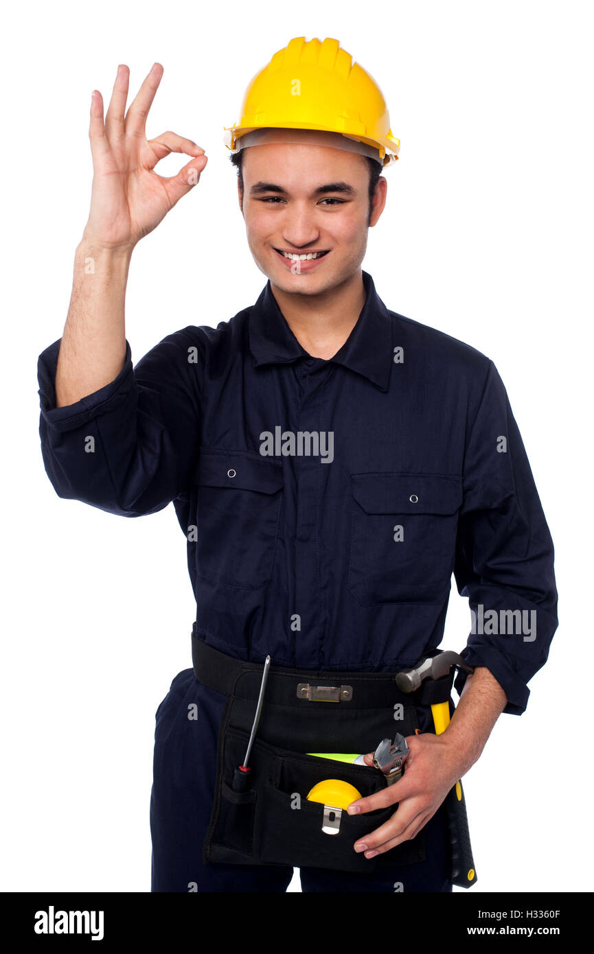 Young male worker giving the ok sign Stock Photo - Alamy