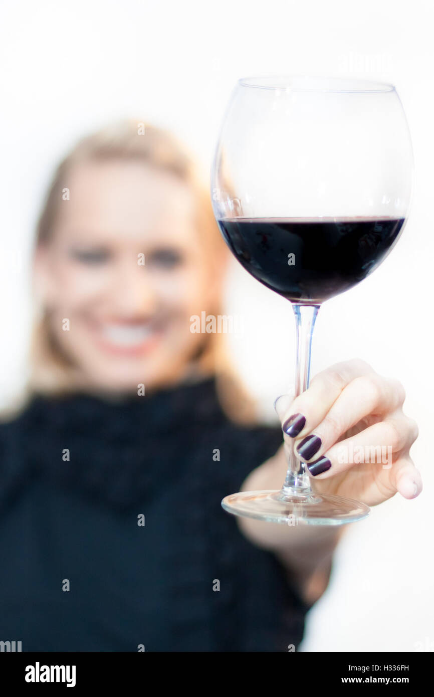 Toasting with a glass of red wine Stock Photo - Alamy