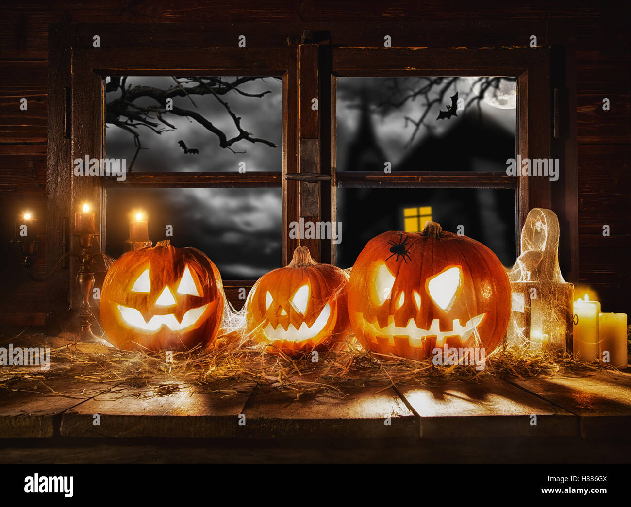 Scary halloween pumpkins on wooden planks, placed in front of window ...