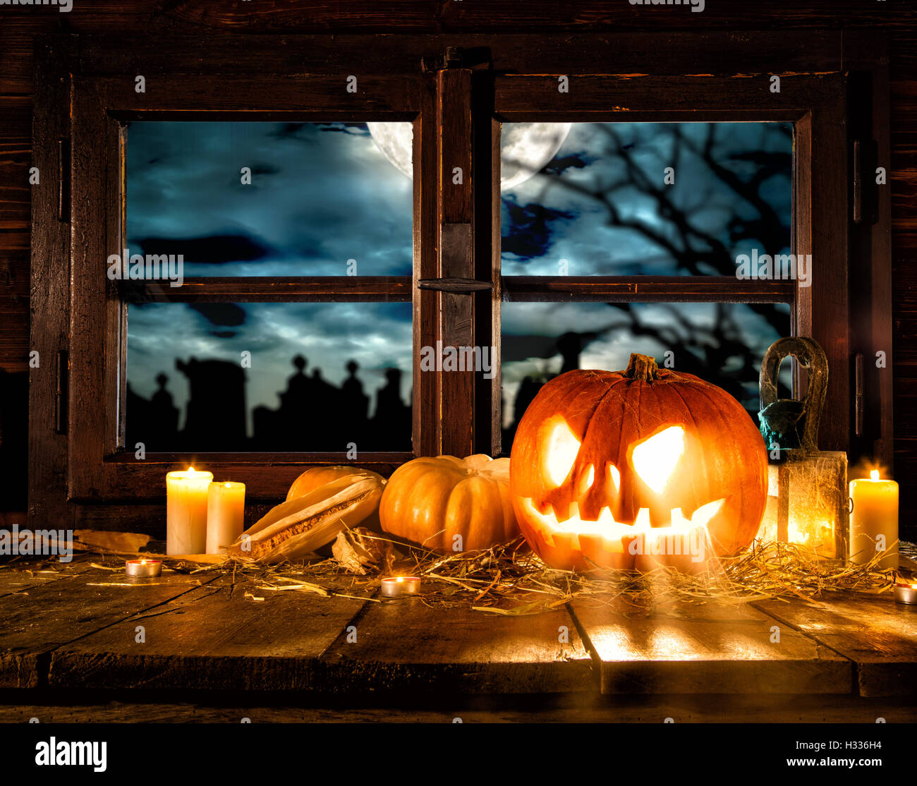Scary halloween pumpkin on wooden planks, placed in front of window ...