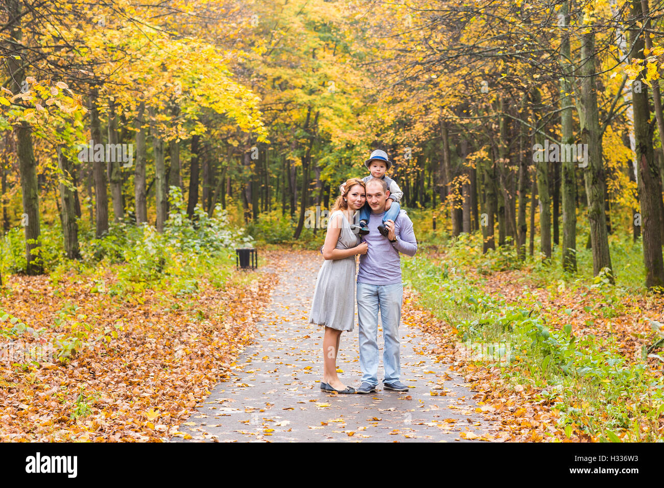 Happy family playing piggyback in autumn park Stock Photo - Alamy
