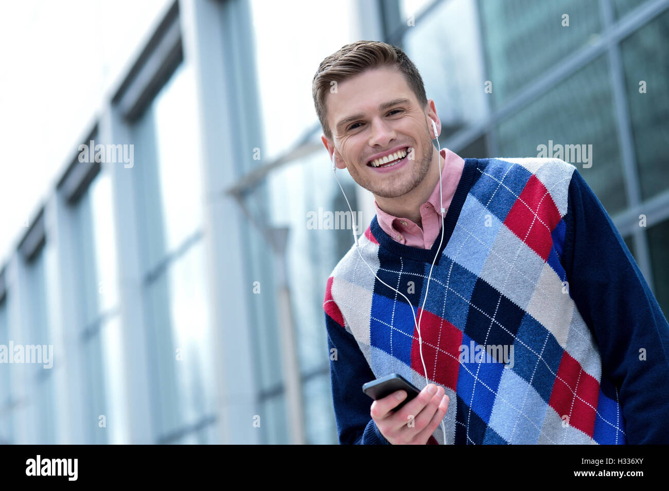 Handsome young man listening to music Stock Photo - Alamy