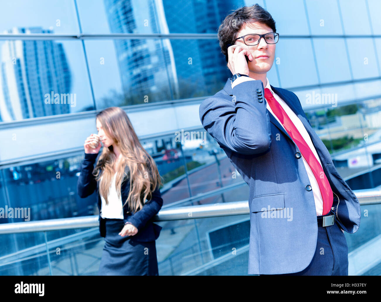 Junior executive dynamic phoning outside of his office Stock Photo - Alamy