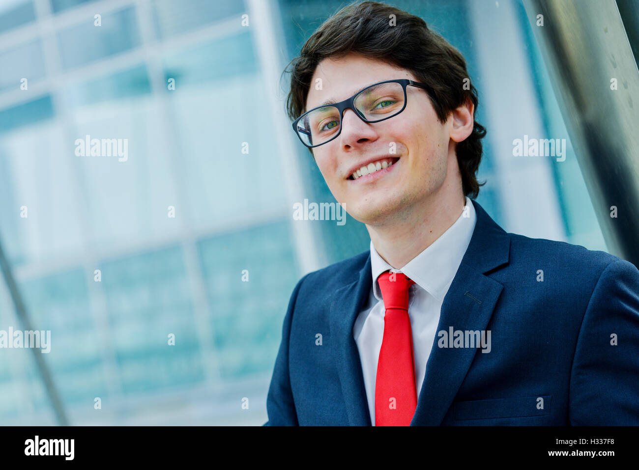 Outdoor portrait of a dynamic junior executive smiling Stock Photo - Alamy