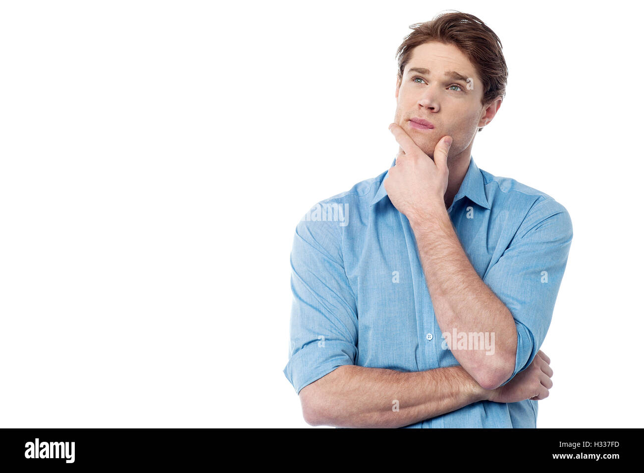 Handsome young man thinking something Stock Photo - Alamy