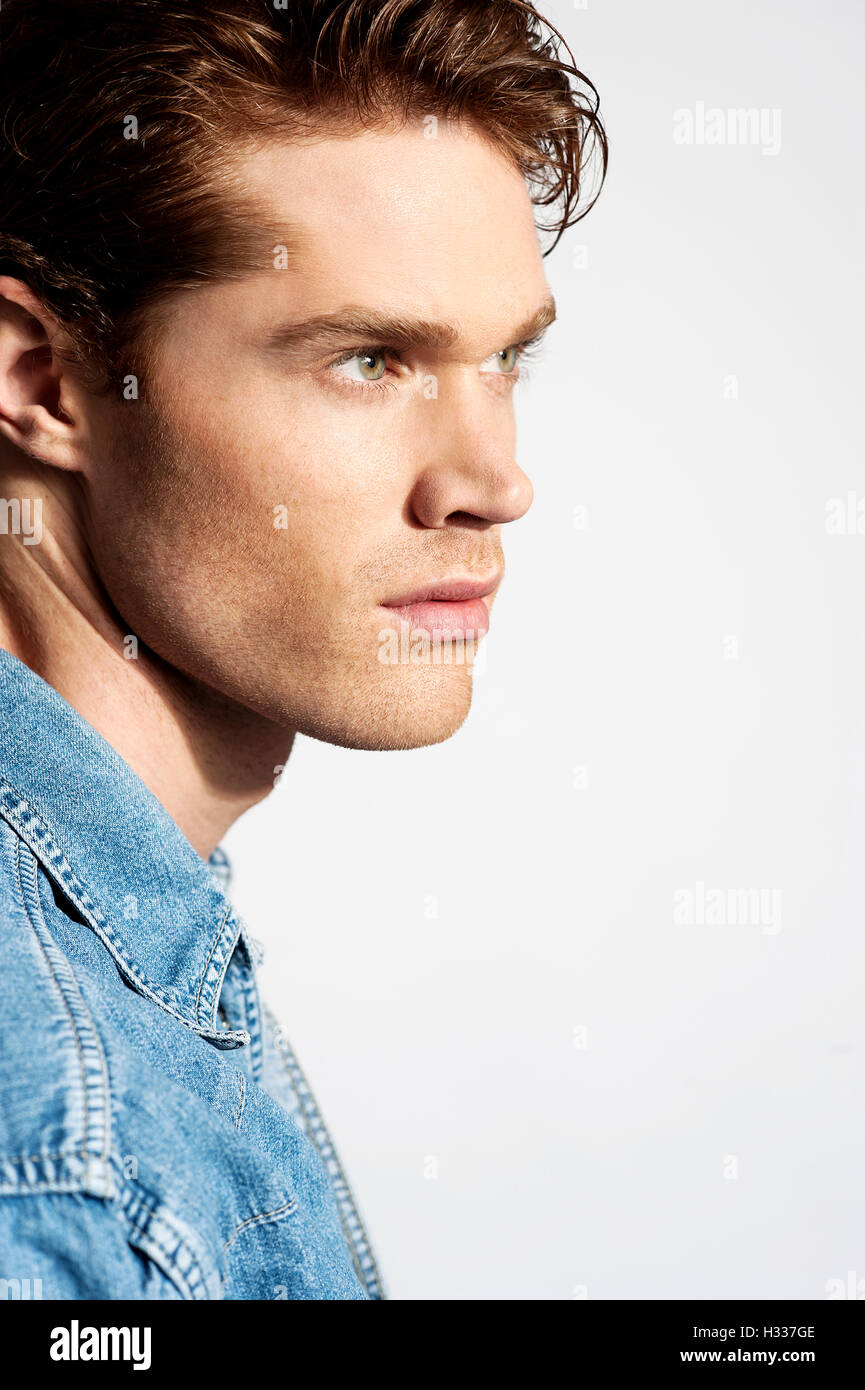 Handsome young male model looking outside Stock Photo - Alamy