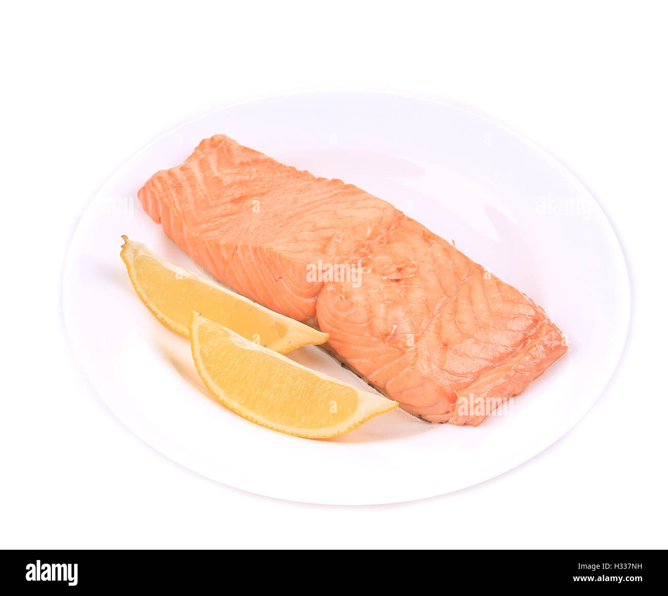 Fried salmon fillet on plate with lemon Stock Photo - Alamy