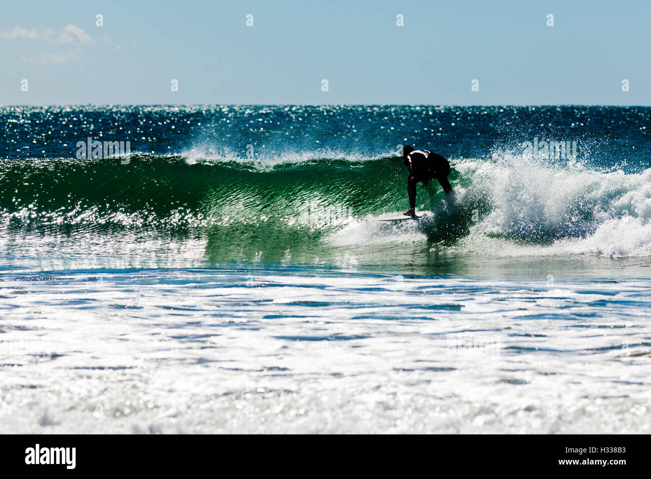 Surfboard surfer rides wave ocean surf Stock Photo - Alamy