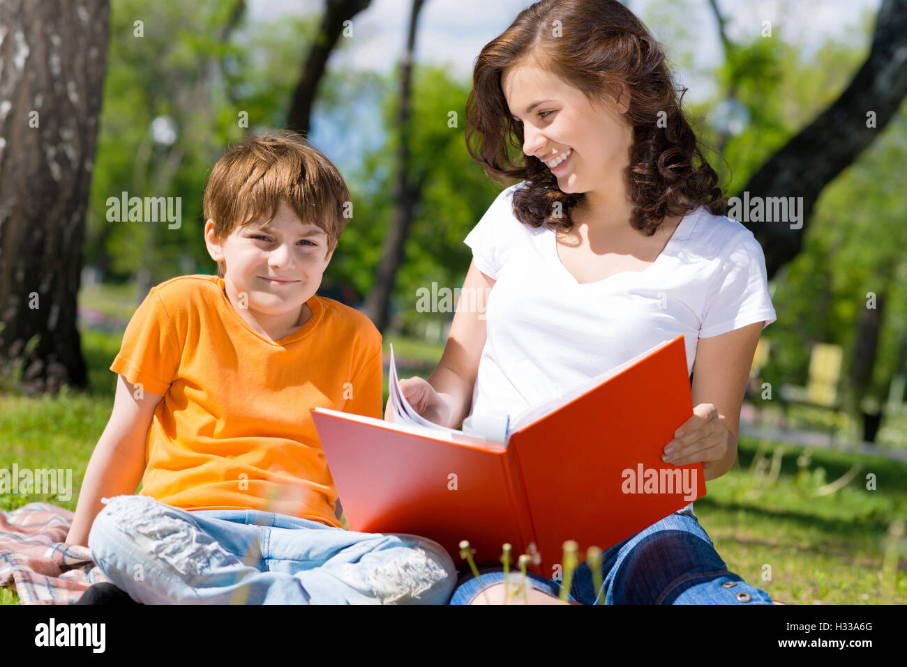 reading a book together Stock Photo - Alamy