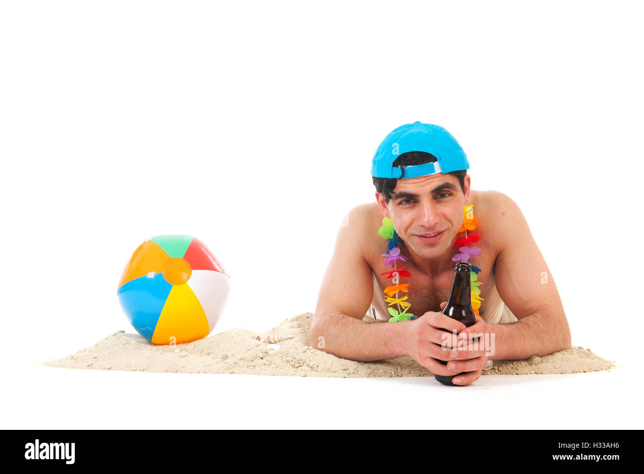 Young man at the beach drinking beer Stock Photo - Alamy