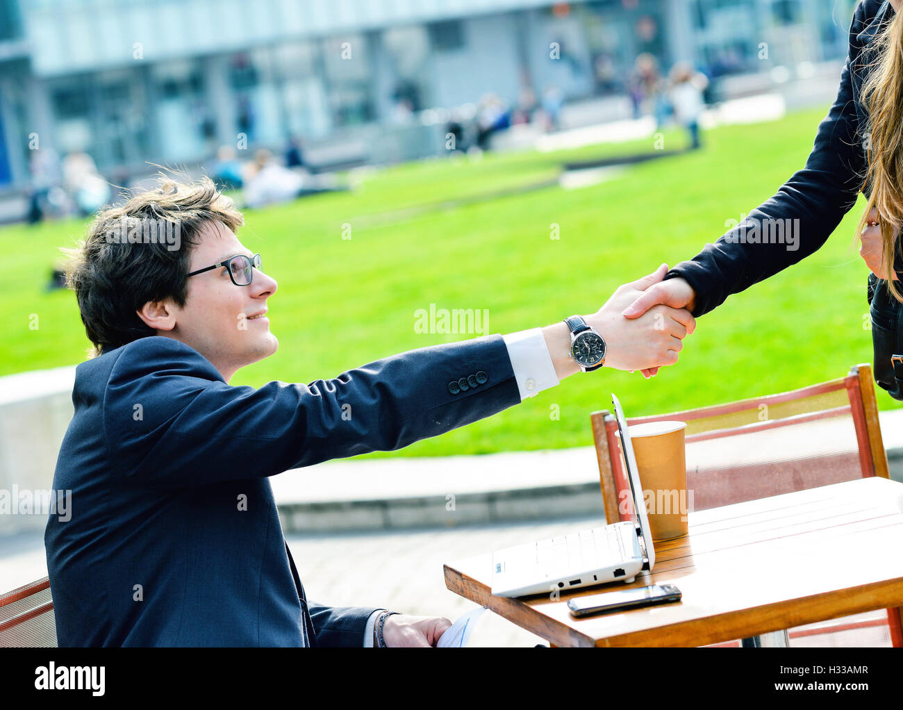 Happy young graduate shaking hand hi-res stock photography and images ...
