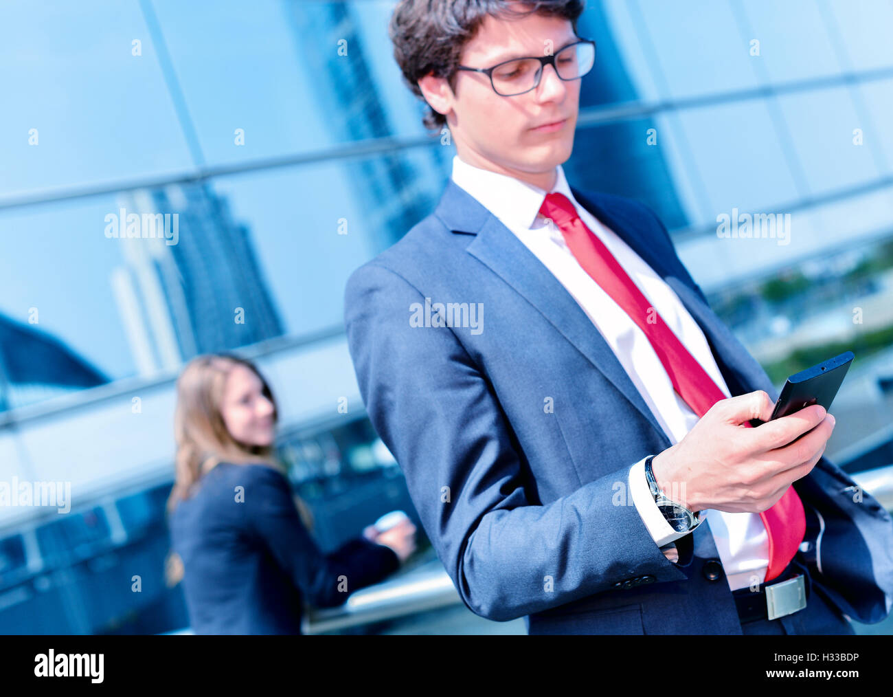 Junior executive dynamic phoning outside of his office Stock Photo - Alamy