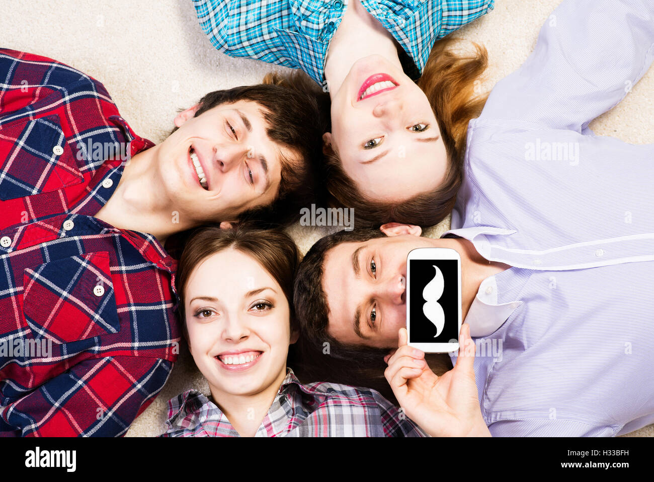 four young men lie together Stock Photo - Alamy