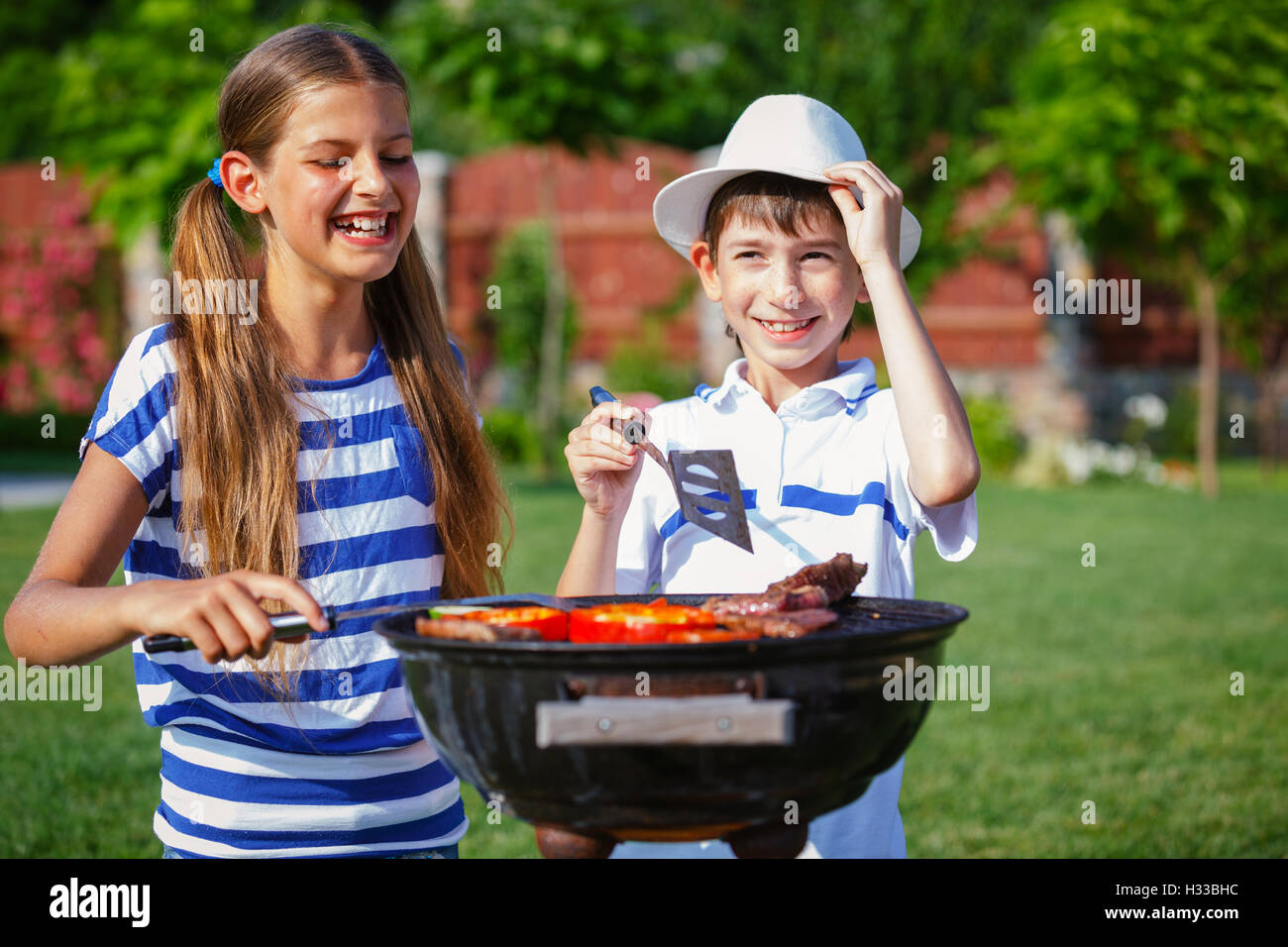 Kids having a barbecue party Stock Photo - Alamy