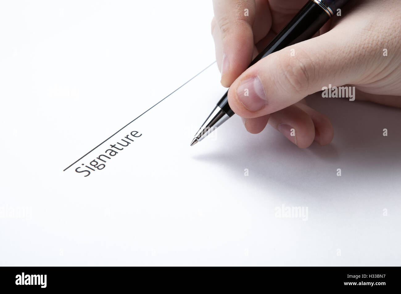 Mans hand signing document hi-res stock photography and images - Alamy