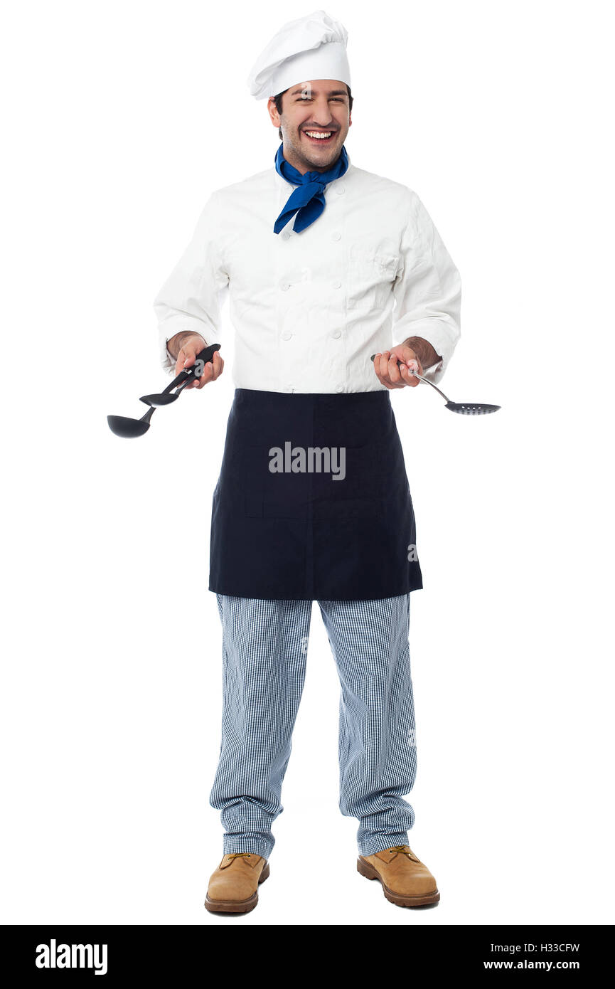 Smiling chef with kitchen utensils Stock Photo - Alamy