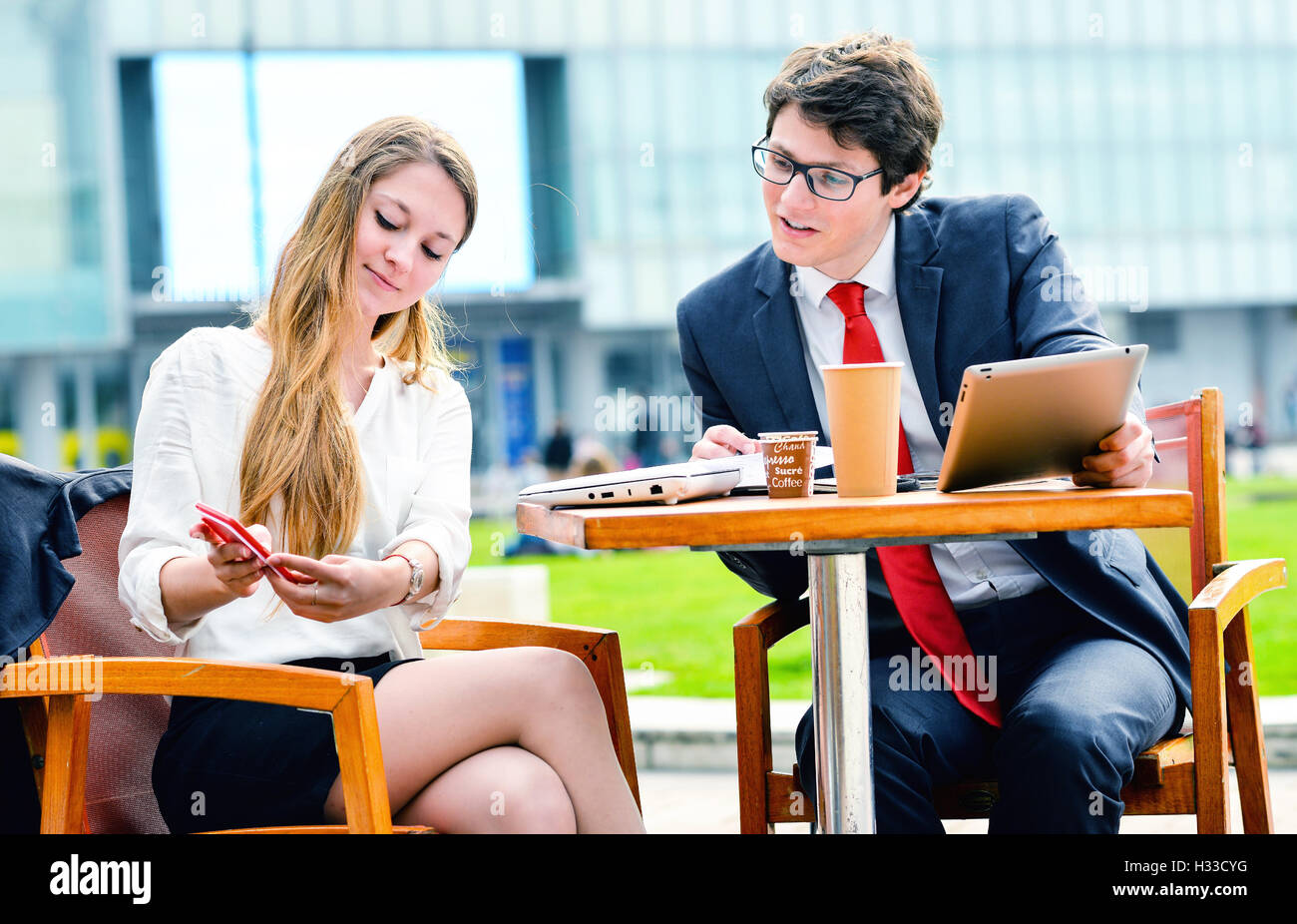 Junior executives dynamics working outside of their office Stock Photo ...