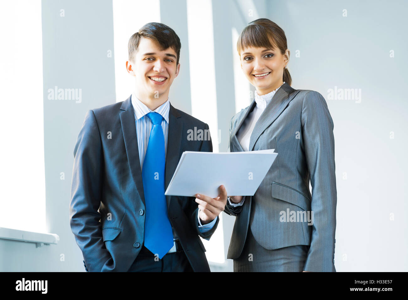 two business partners discussing reports Stock Photo - Alamy