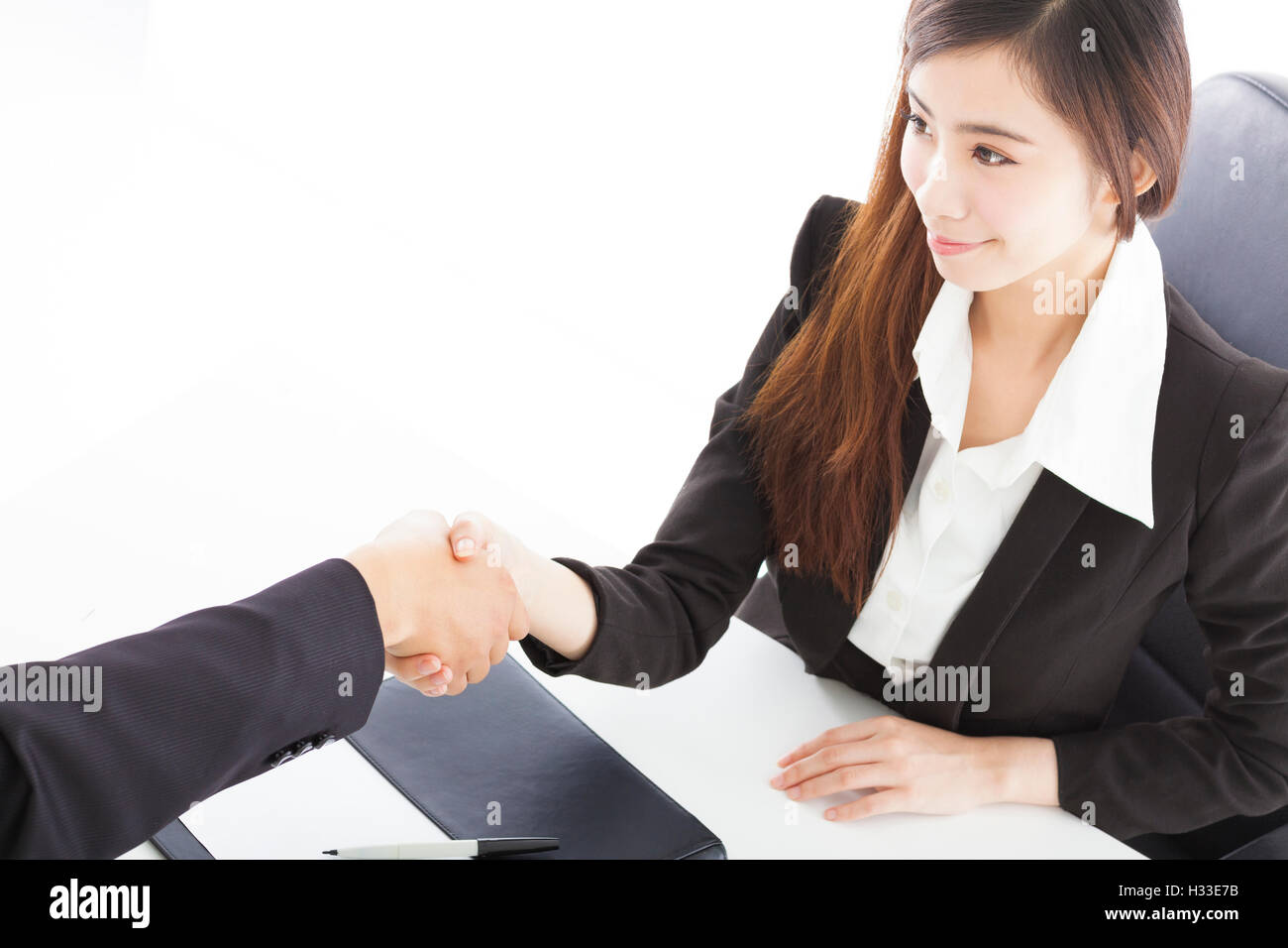smiling business woman shaking hands with client in her office Stock ...