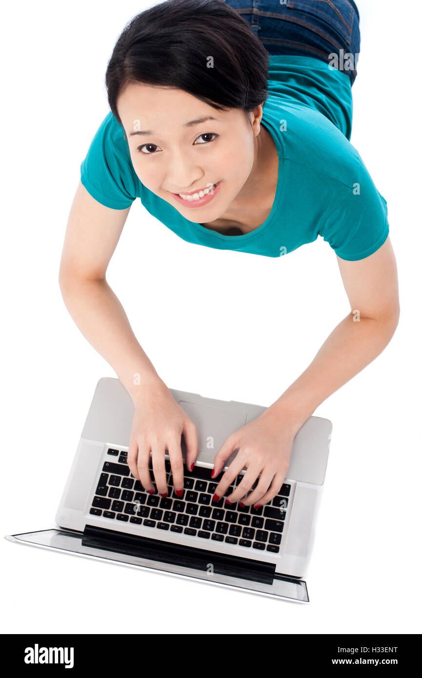 Young woman lying on floor using laptop Stock Photo - Alamy