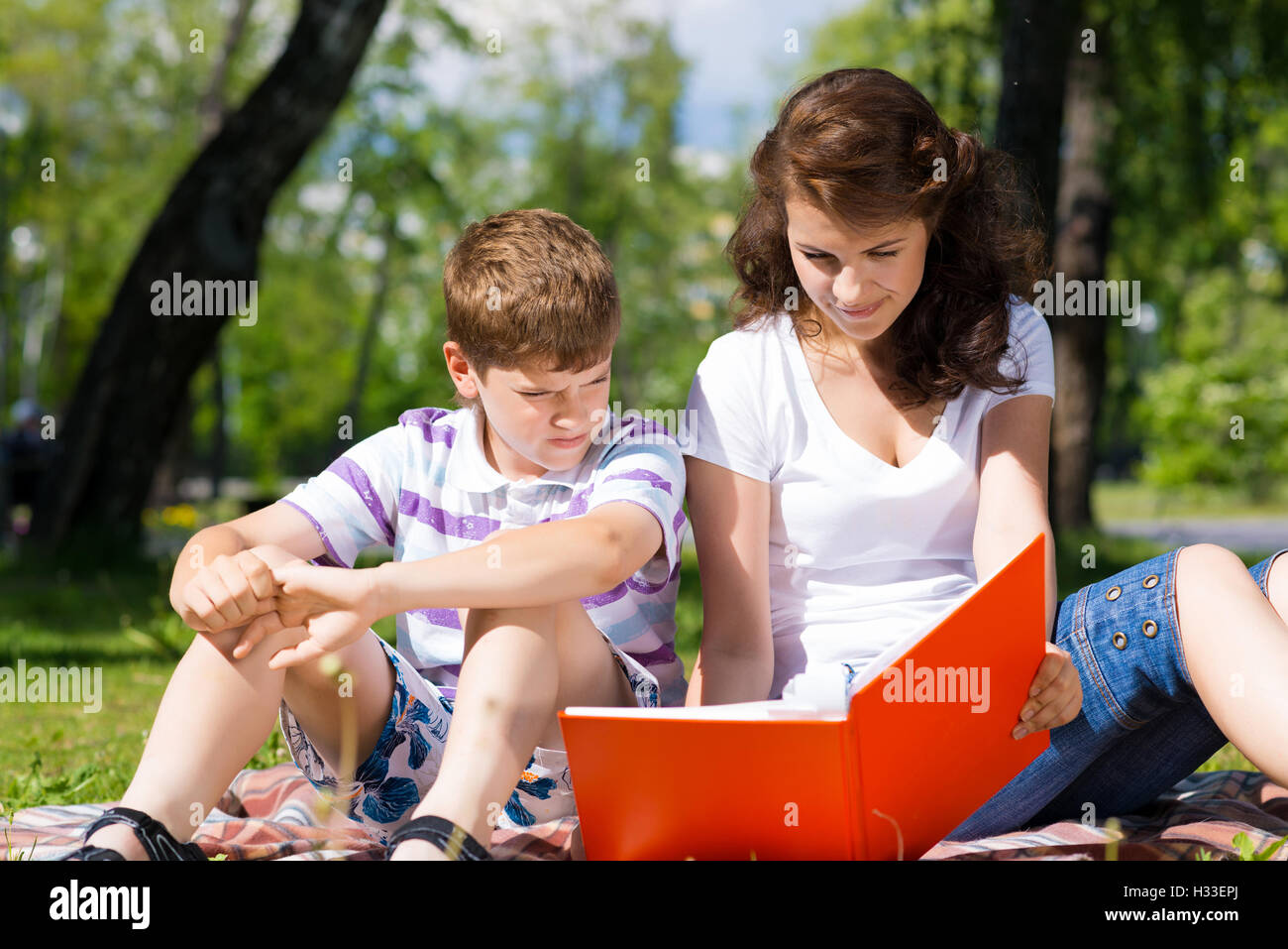 reading a book together Stock Photo - Alamy