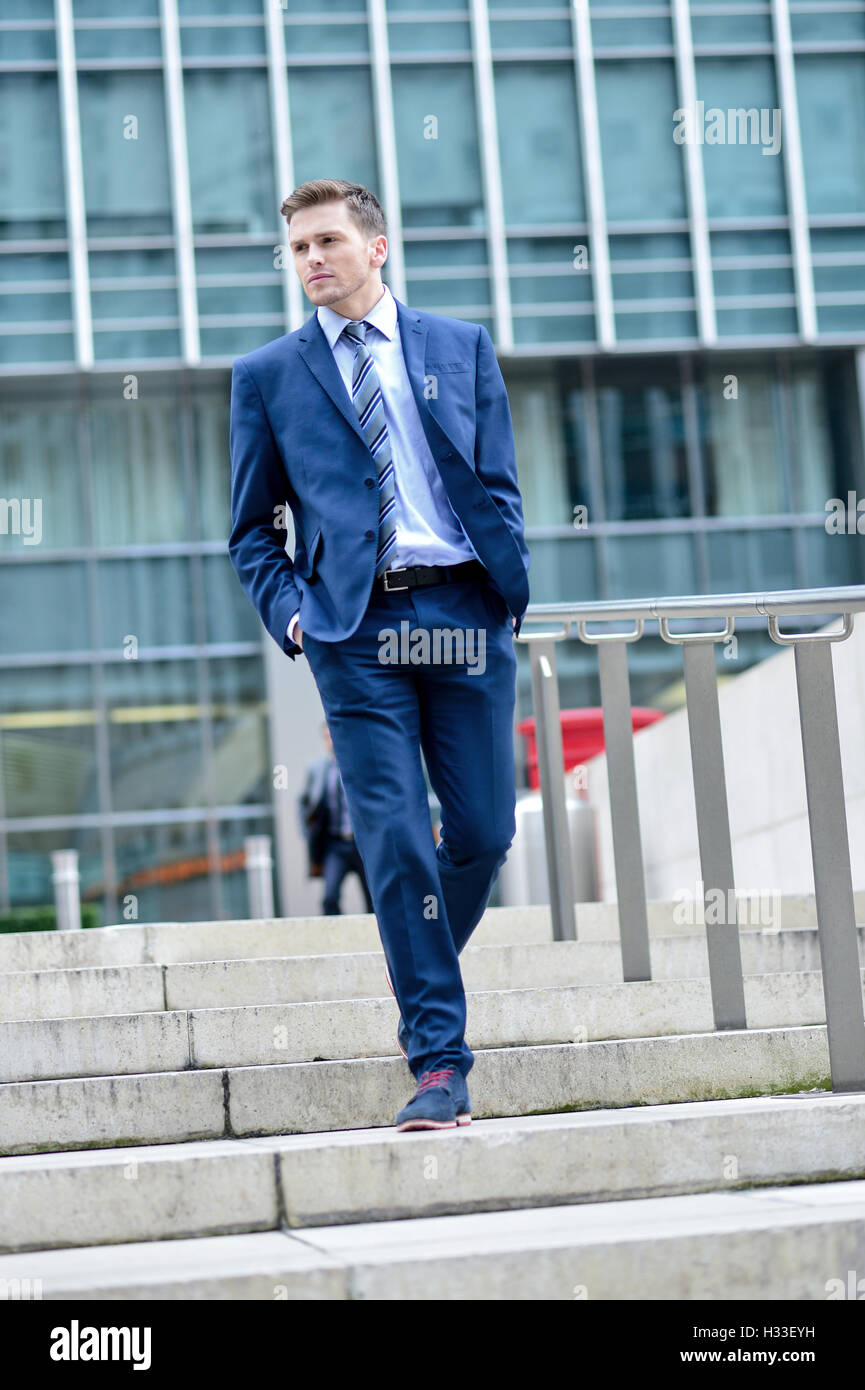 Smart man walking down steps hi-res stock photography and images - Alamy