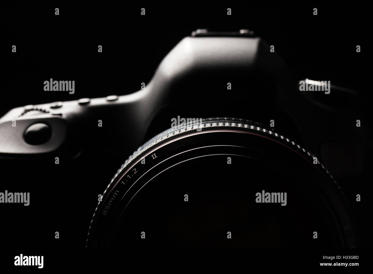 Professional modern DSLR camera low key image Stock Photo - Alamy