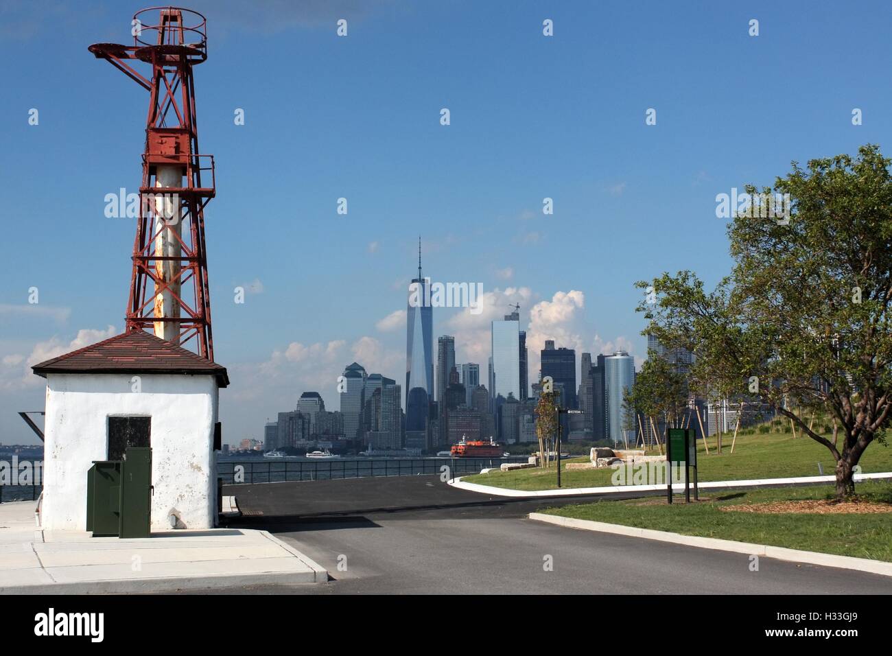 Governors Island lighthouse overlooking Lower Manhattan skyscrapers ...