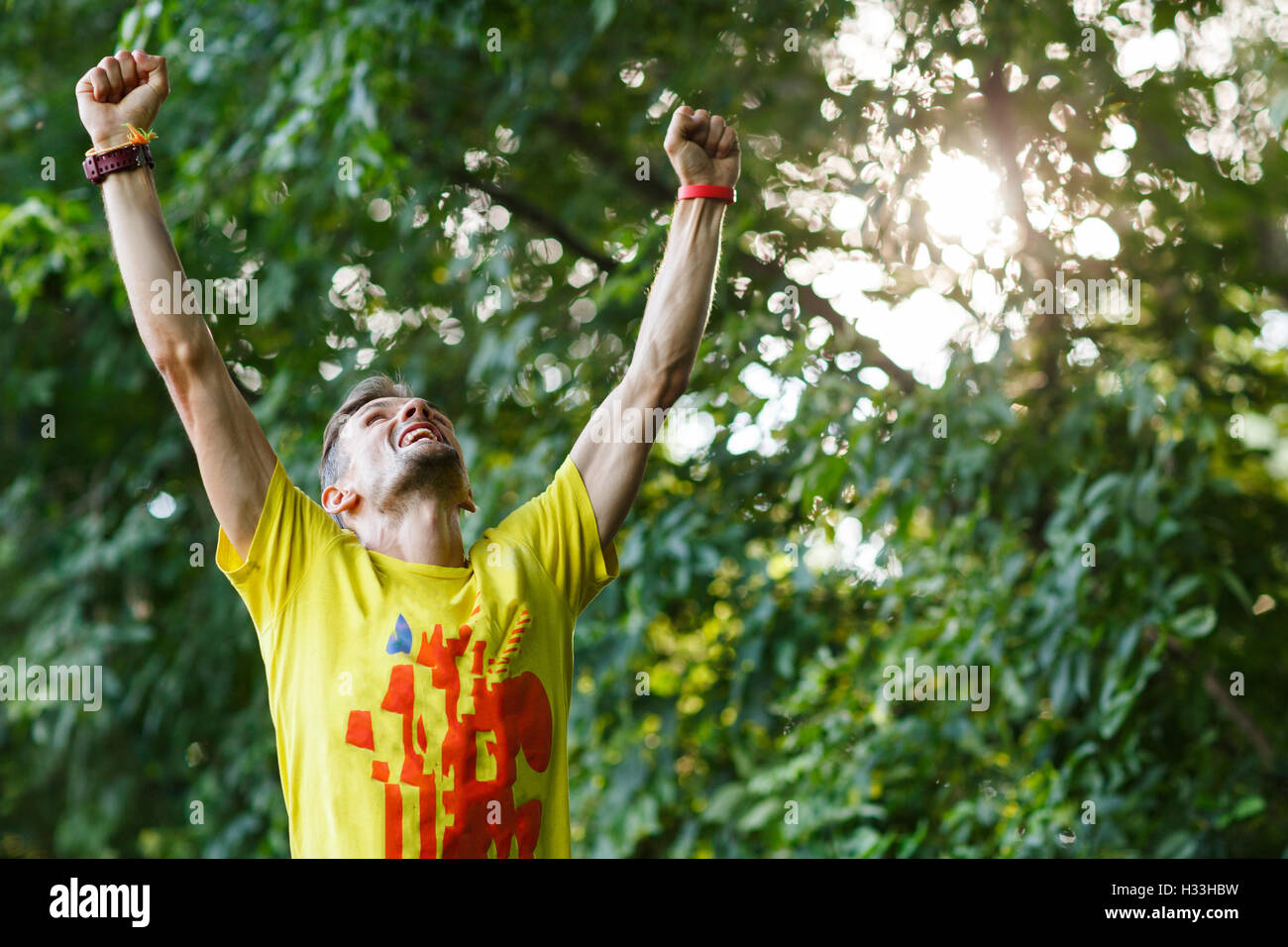 Young sportsman doing exercise in summer park Stock Photo - Alamy
