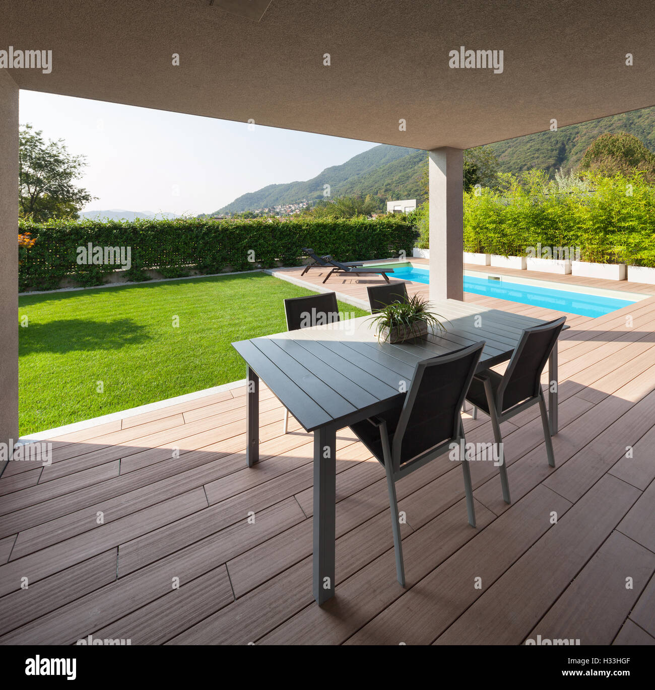 Place to relax under a porch, modern house with pool Stock Photo - Alamy