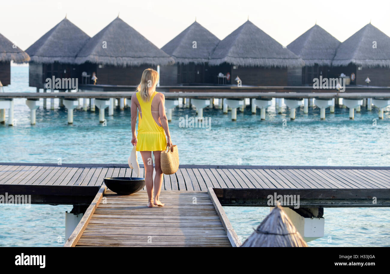Rear View Of Woman Running Along Wooden Jetty Stock Photo - Alamy