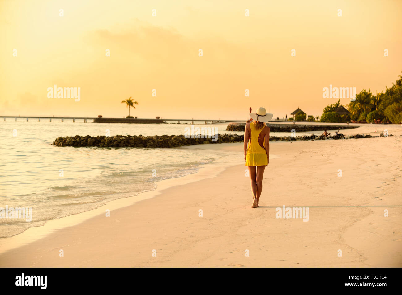 Rear View Of Woman Running Along Wooden Jetty Stock Photo - Alamy